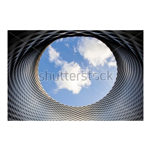 Постер на холсте Деталь современной архитектуры в виде круглого тоннеля с видом на облачное небо 75см. x 50см.